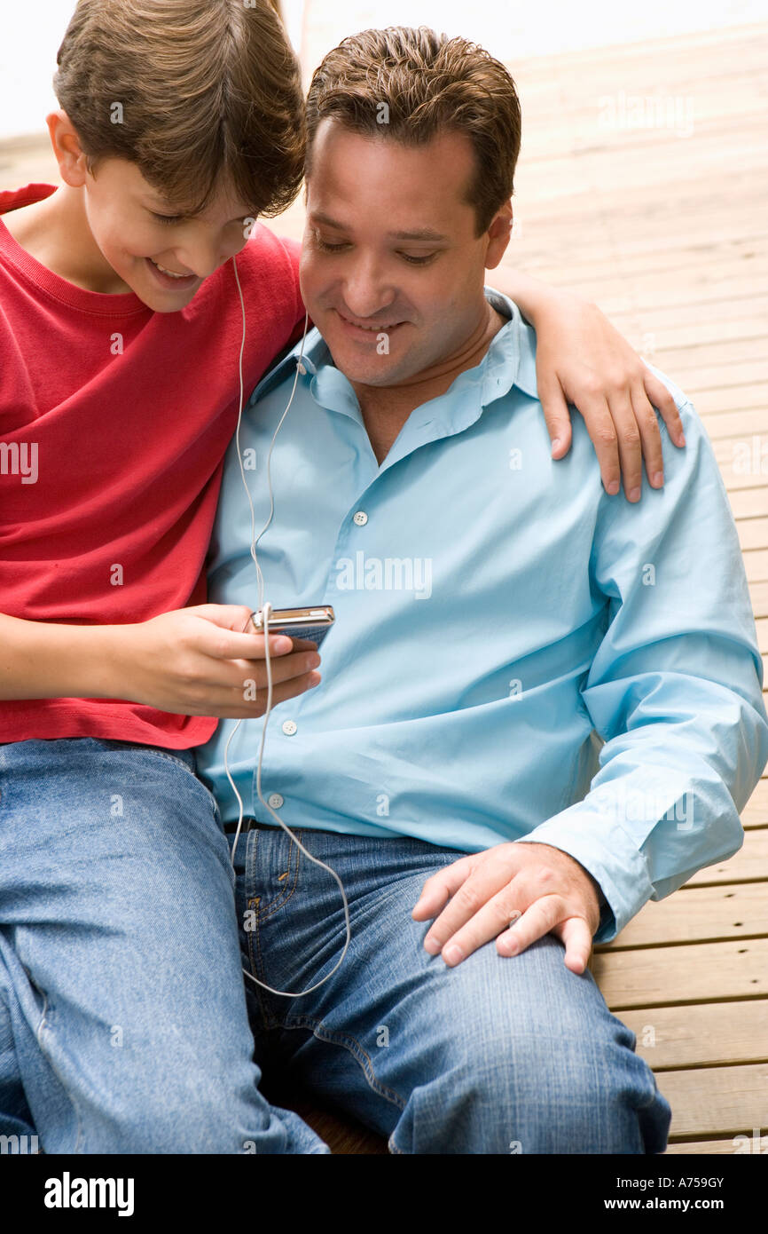 Father and son listening to mp3 player hi-res stock photography and ...