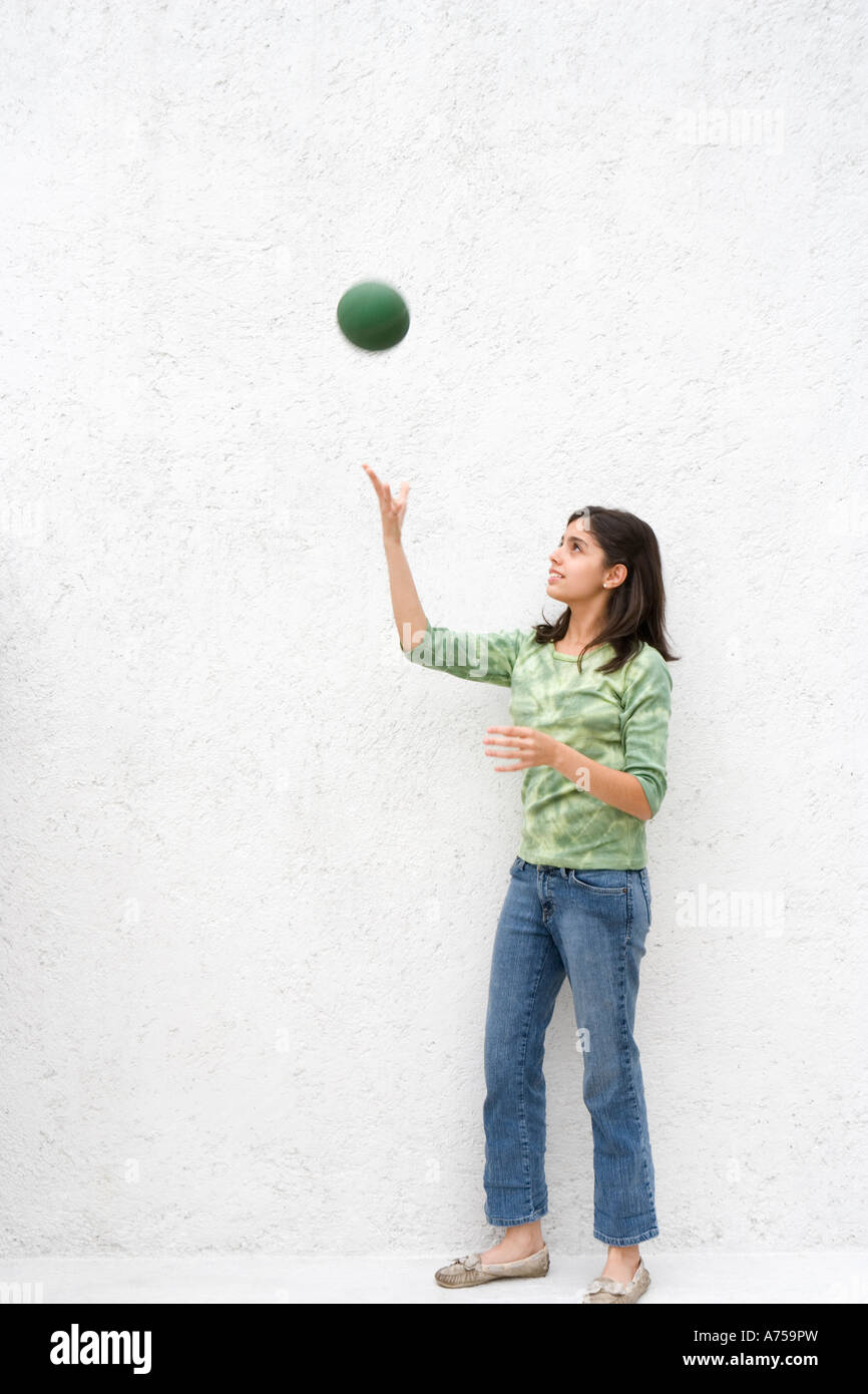 Young girl tossing basketball Stock Photo - Alamy