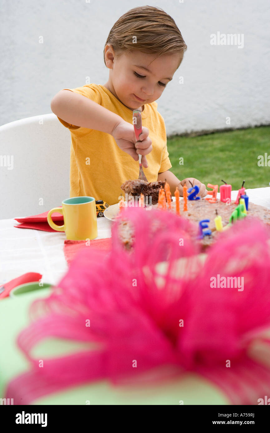 Toddler boy eating birthday cake Stock Photo - Alamy