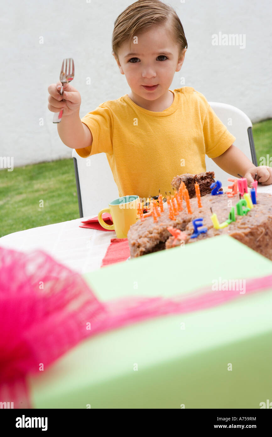 Toddler boy eating birthday cake Stock Photo - Alamy