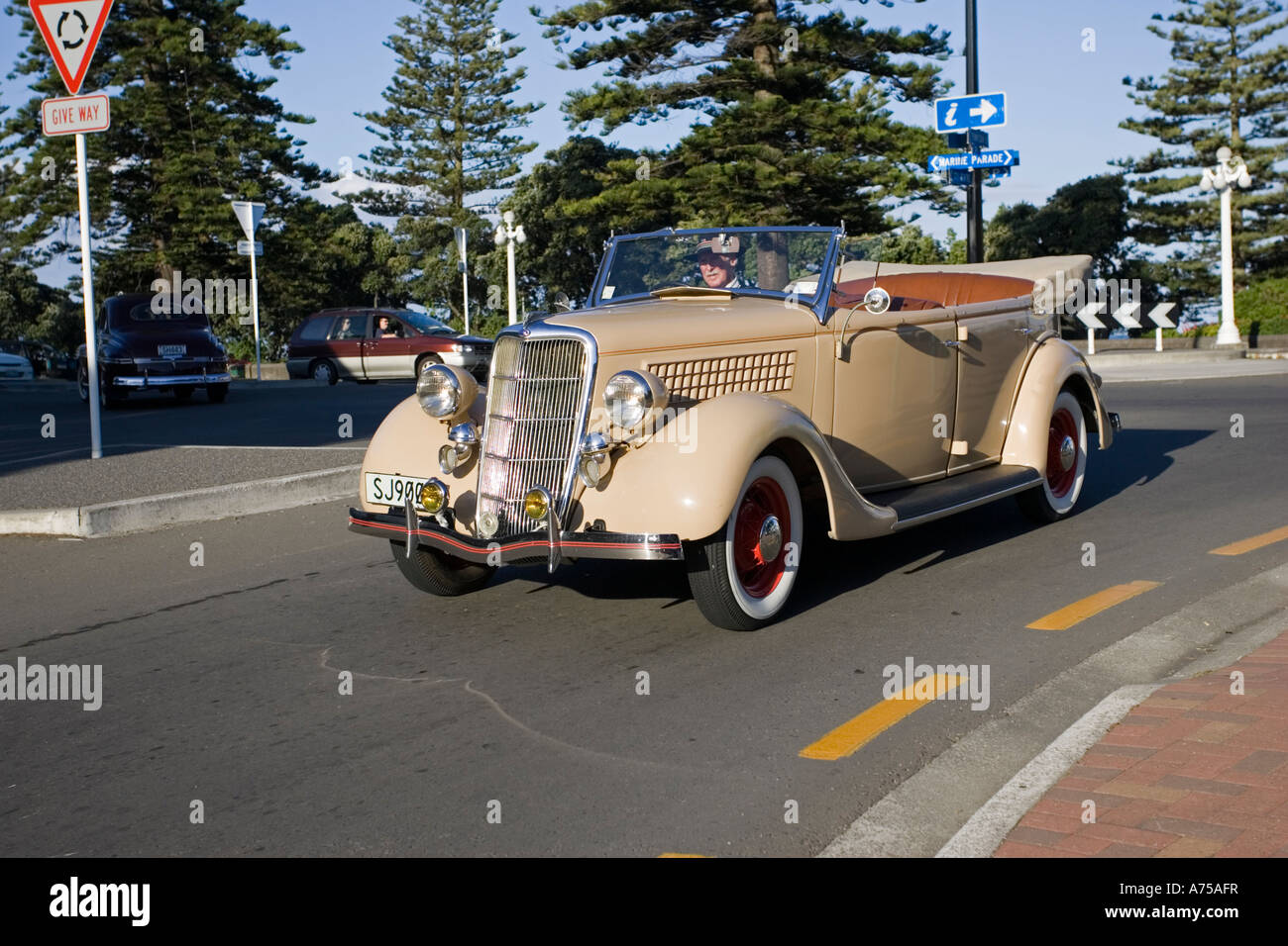 Classic vintage buff Ford tourer motor car on road Art Deco weekend ...