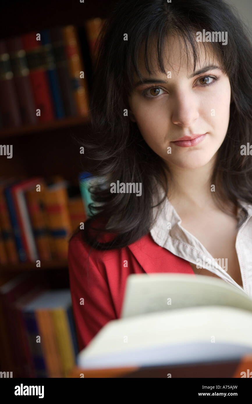 Businesswoman reading a thick book Stock Photo - Alamy