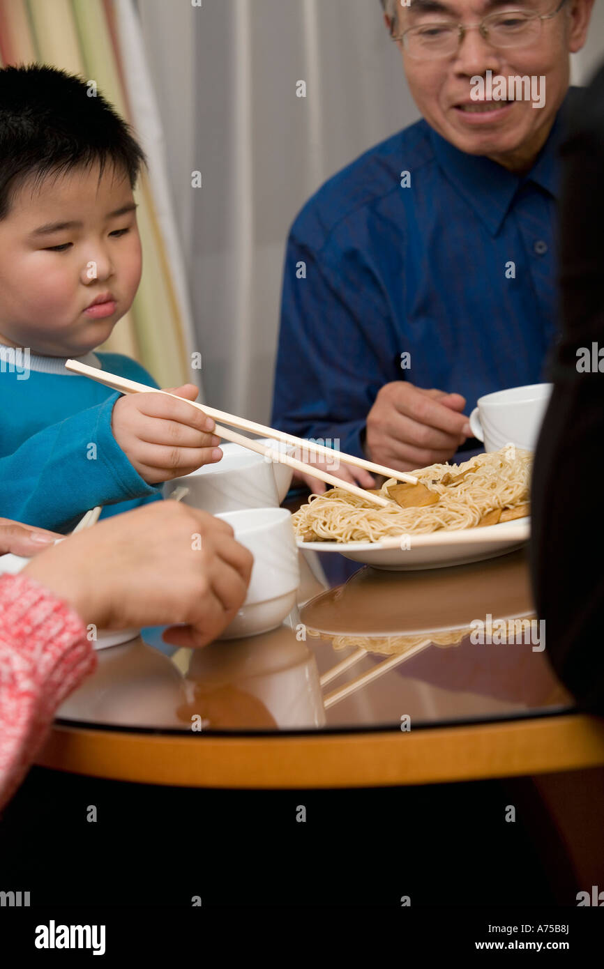 Family eating at dinner table Stock Photo - Alamy