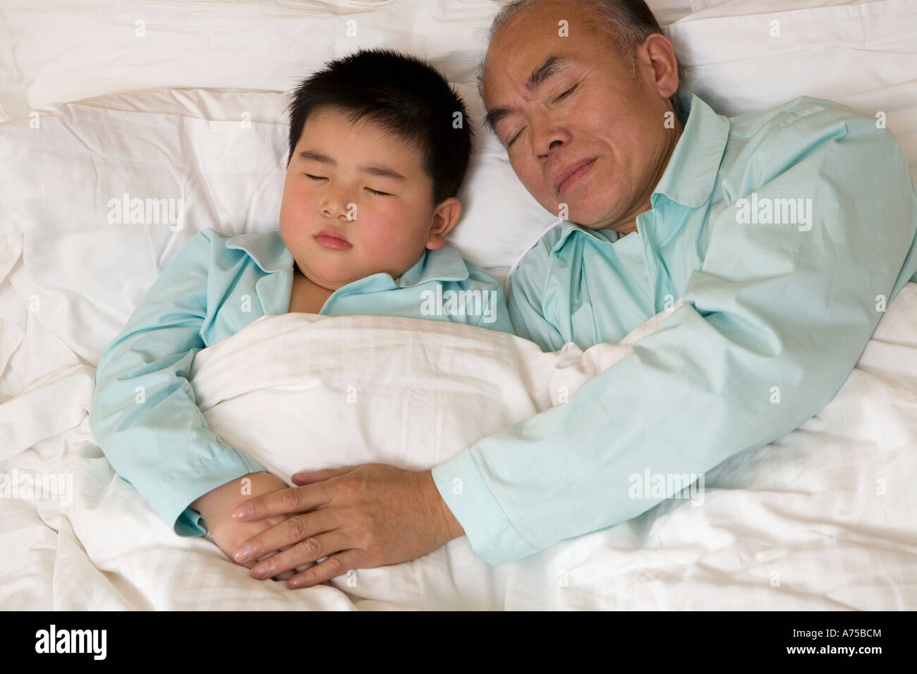Grandfather holding sleeping grandson hi-res stock photography and ...