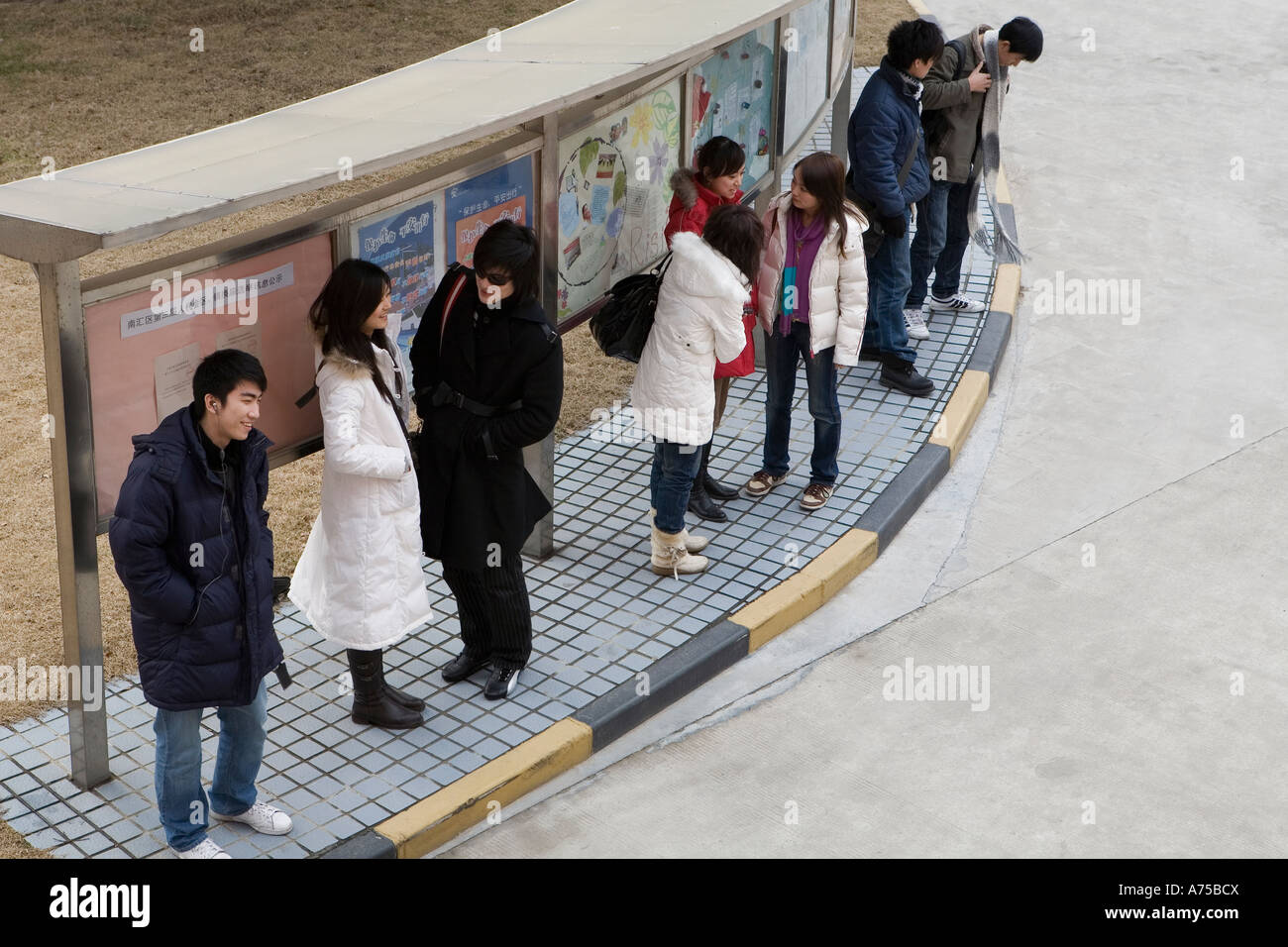 Chinese woman waiting bus stop hi-res stock photography and images - Alamy