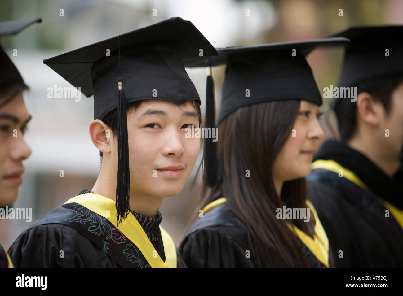 Row of students in graduation robes Stock Photo - Alamy