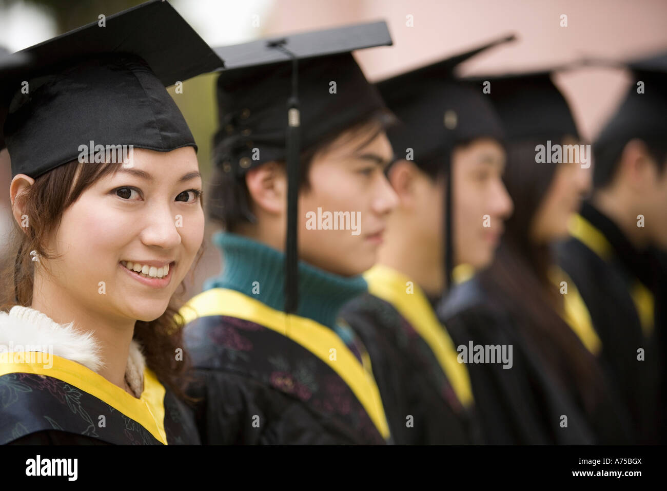 Row of students in graduation robes Stock Photo - Alamy