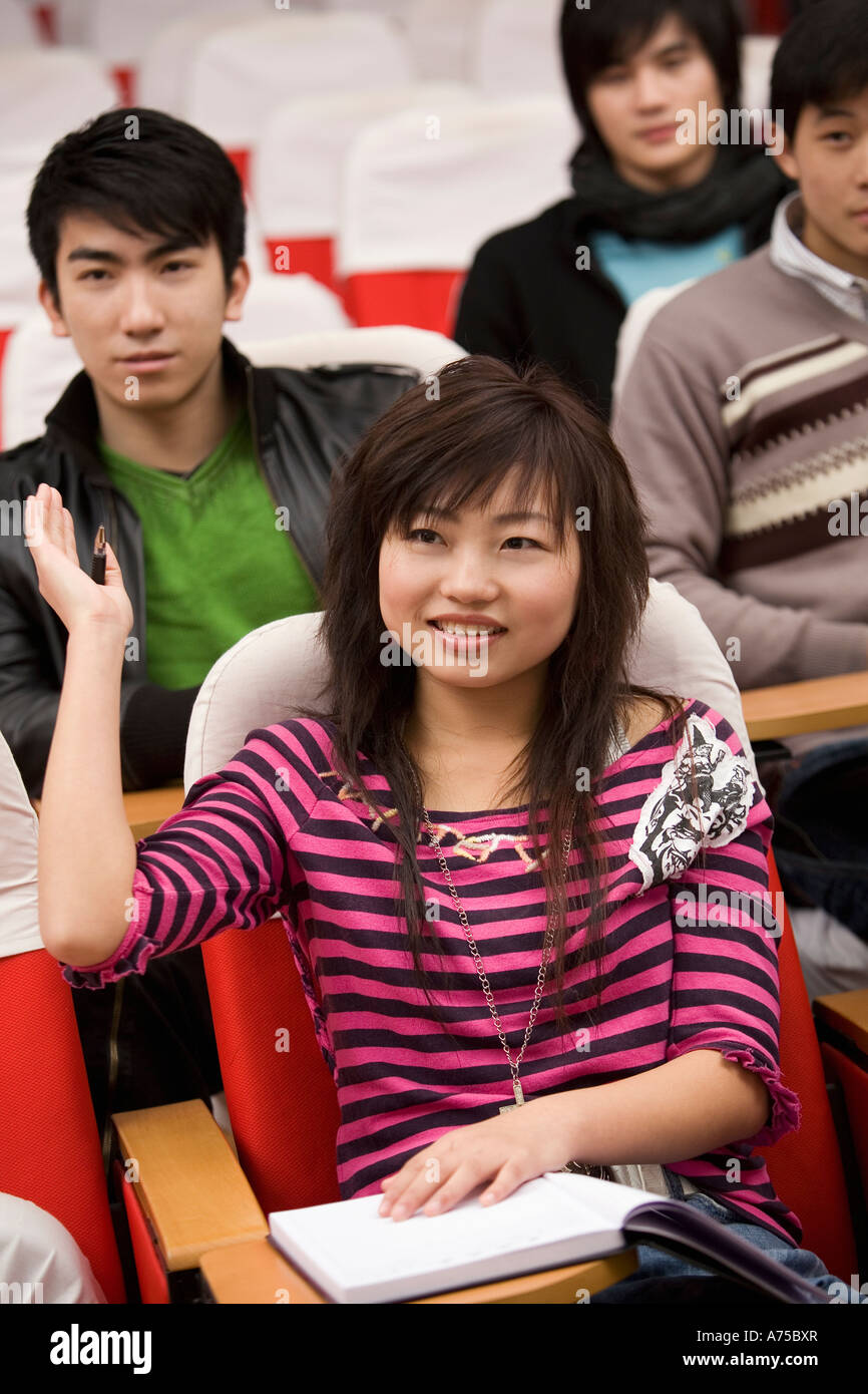 College student raising her hand in class Stock Photo - Alamy