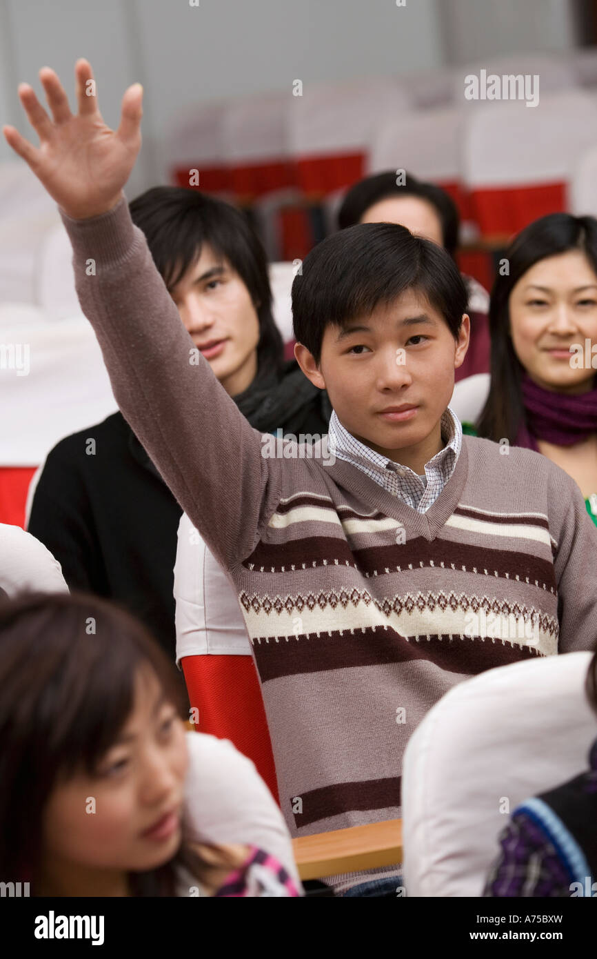 College student raising his hand in class Stock Photo - Alamy