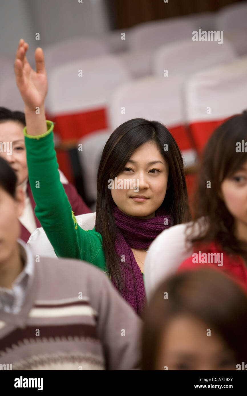 College student raising her hand in class Stock Photo - Alamy