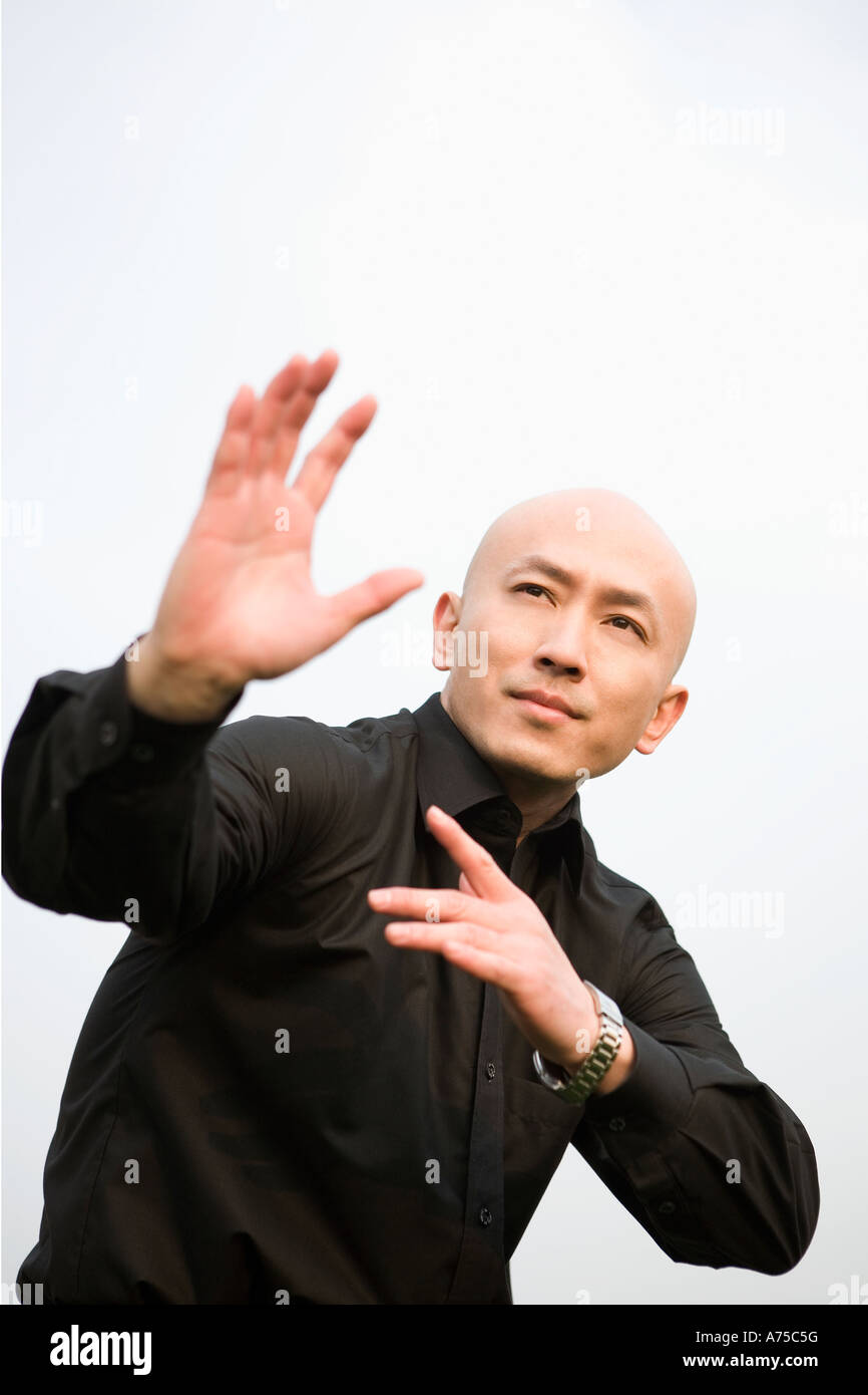 Man practicing tai-chi outdoors Stock Photo - Alamy