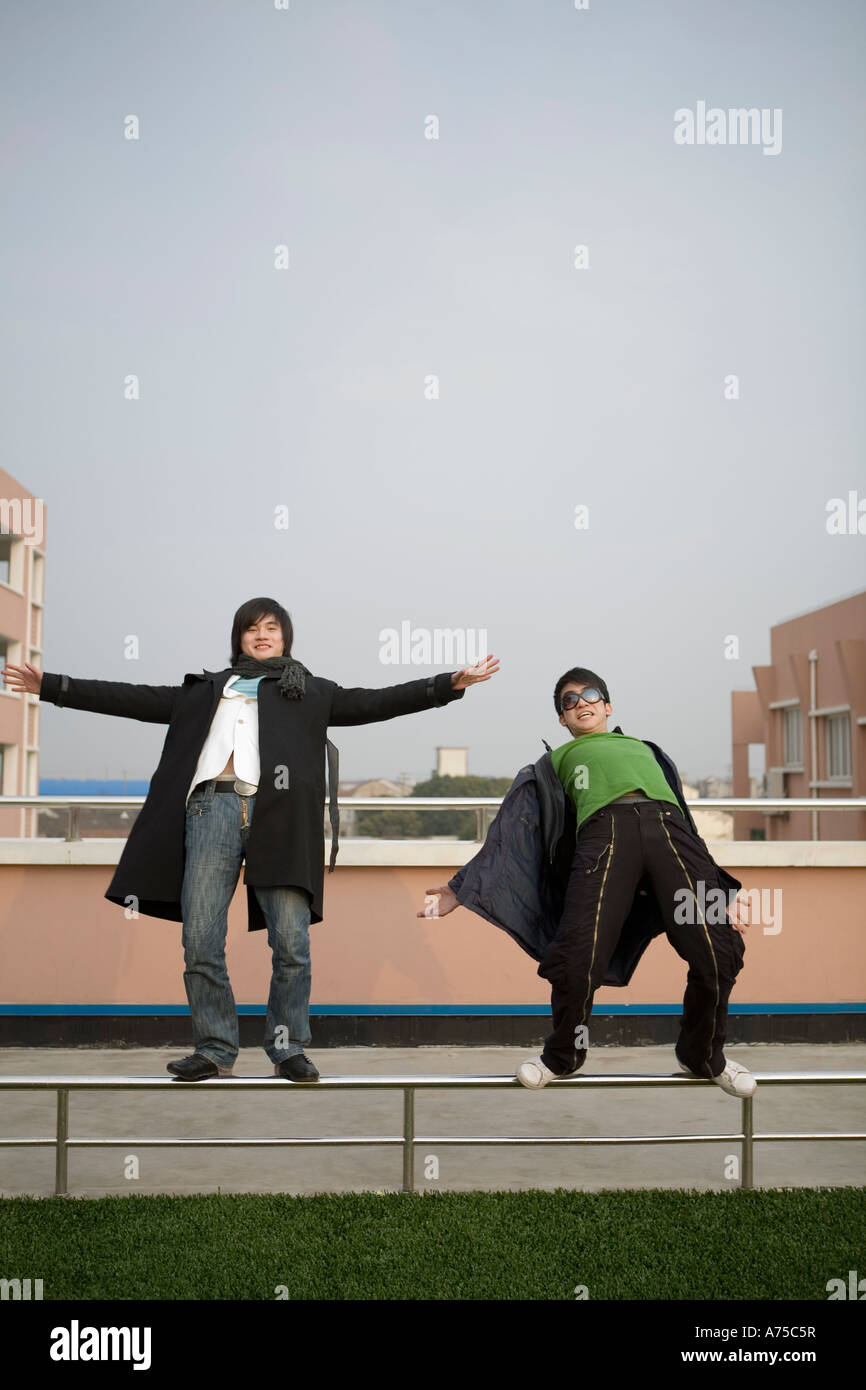 Men balancing on metal railing Stock Photo - Alamy