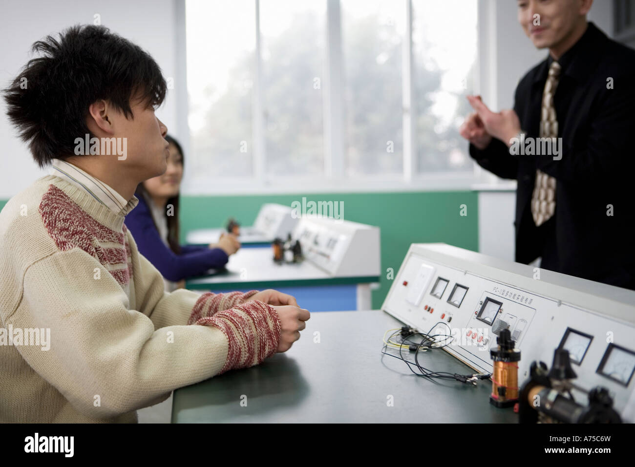 Student listening to teacher Stock Photo - Alamy