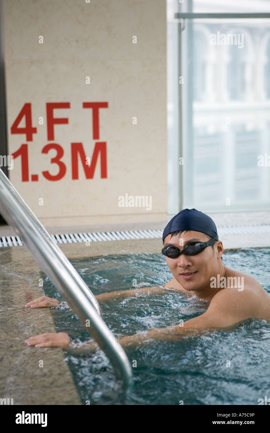 Man climbing out swimming pool hi-res stock photography and images - Alamy