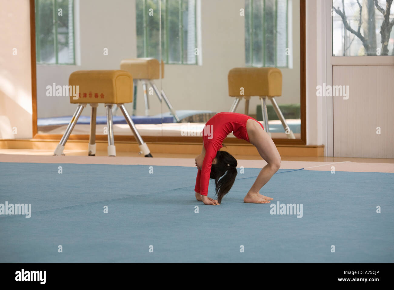 Young girl practicing gymnastics Stock Photo - Alamy
