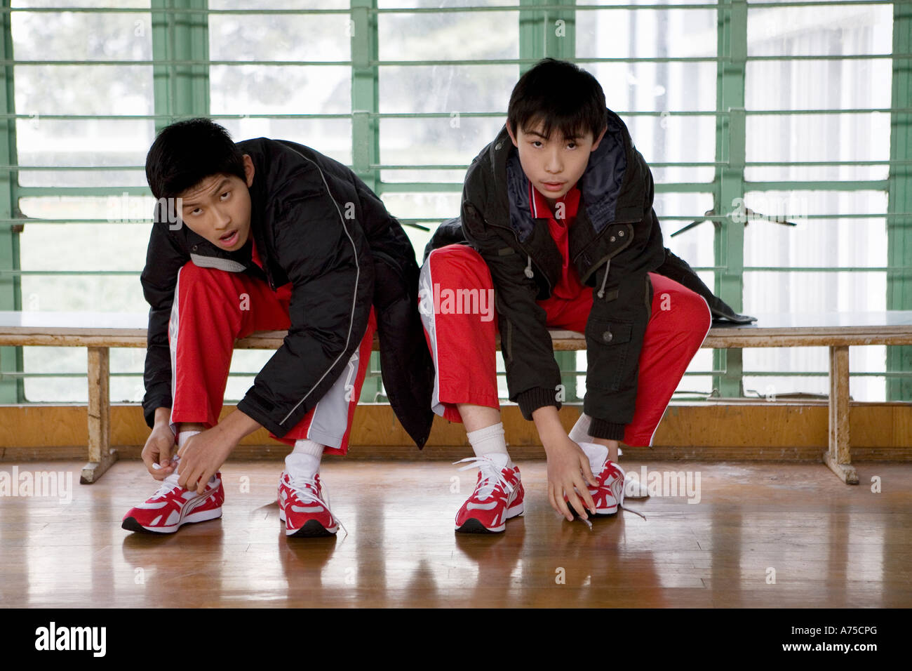 Male athletes tying their shoes Stock Photo - Alamy