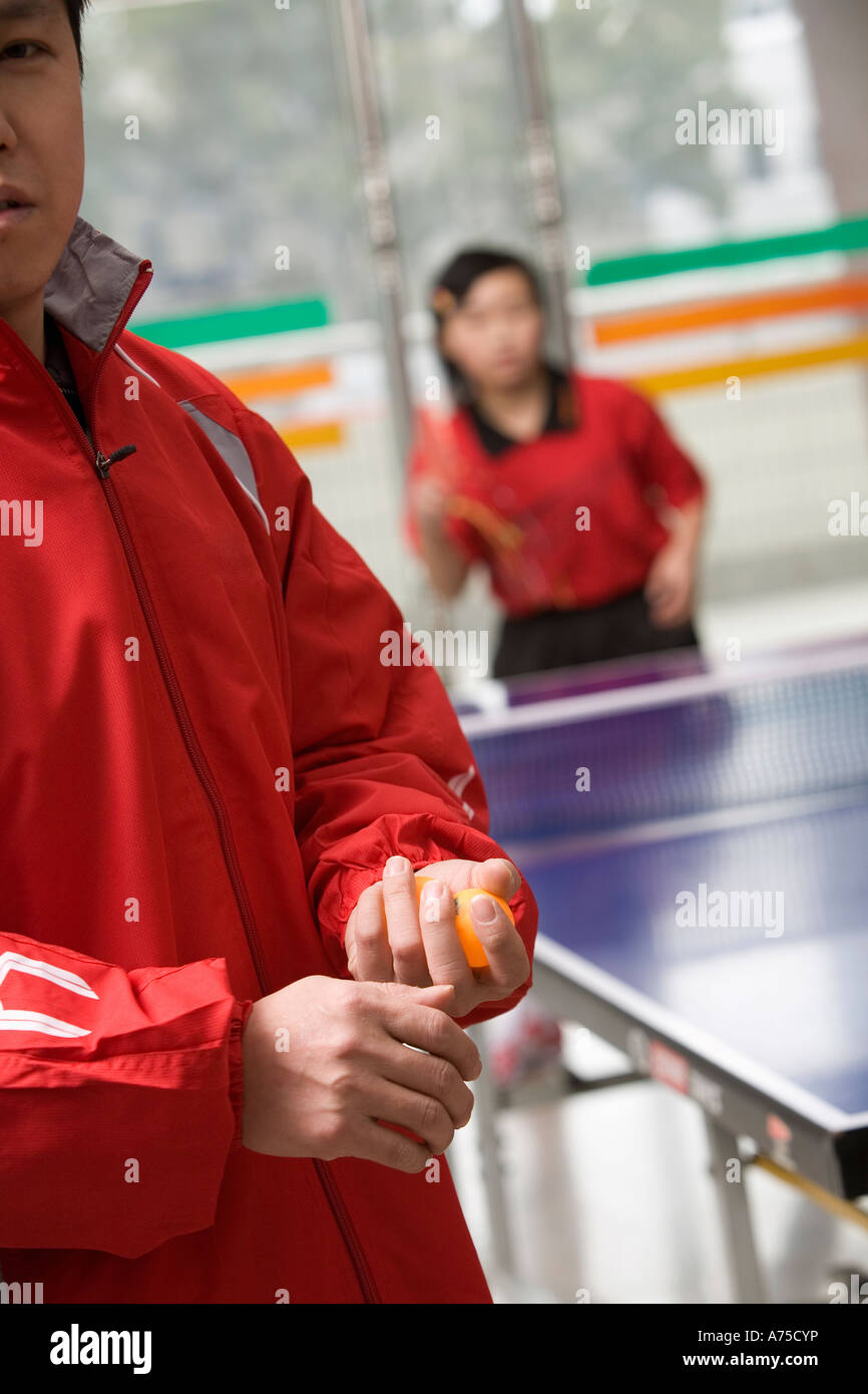 Athletic coach holding ping-pong ball Stock Photo - Alamy