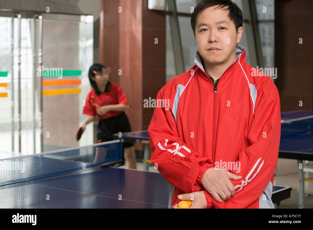 Athletic coach holding ping-pong ball Stock Photo - Alamy