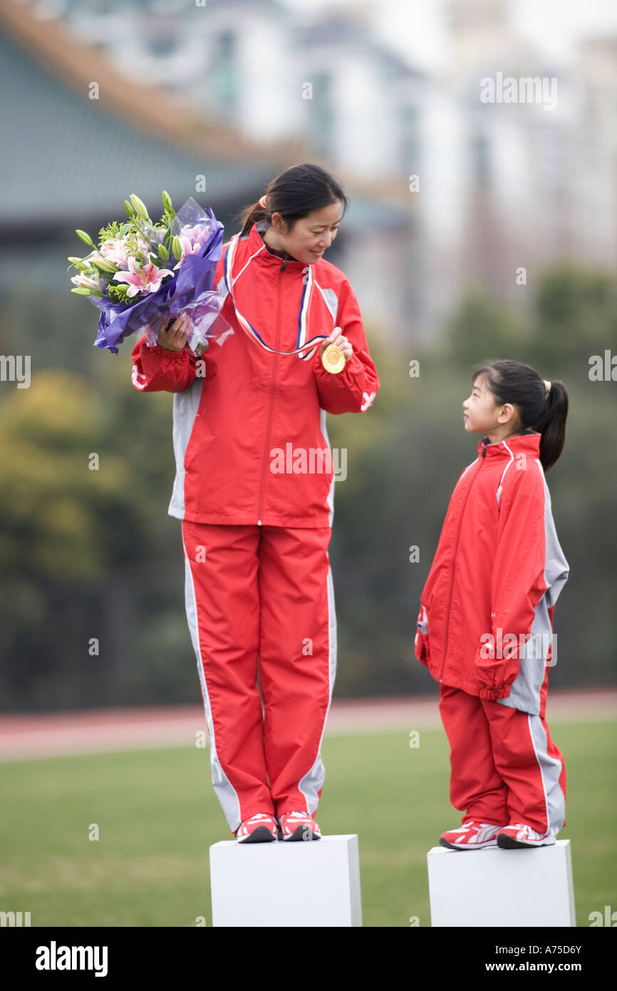 Female athlete wearing gold medal Stock Photo - Alamy