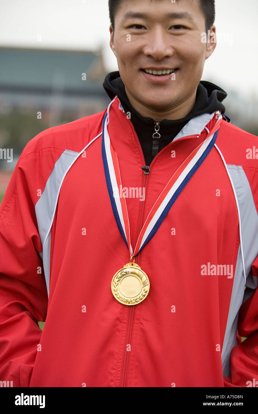 Male athlete wearing a gold medal Stock Photo - Alamy