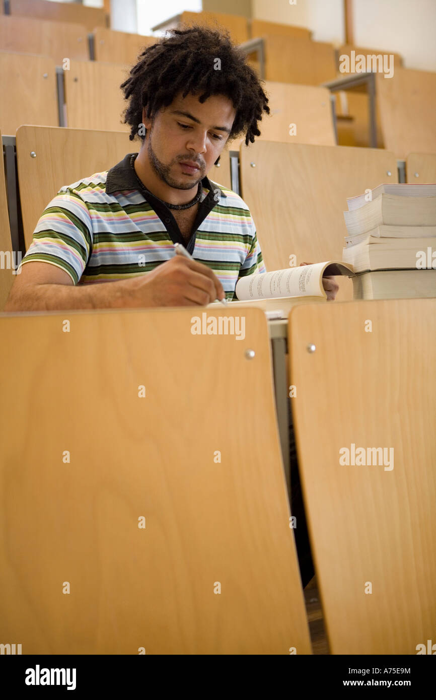 Student studying in empty classroom Stock Photo - Alamy