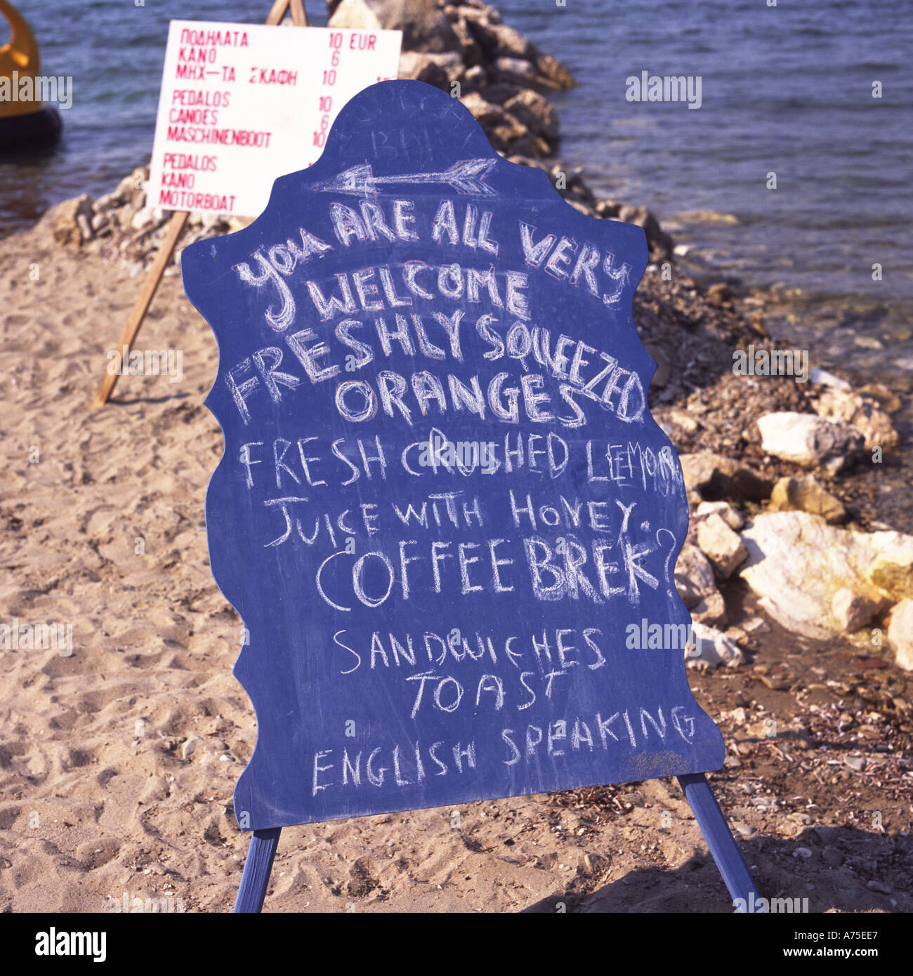 Hand written sign pointing the direction of beach bar on Bouka beach ...