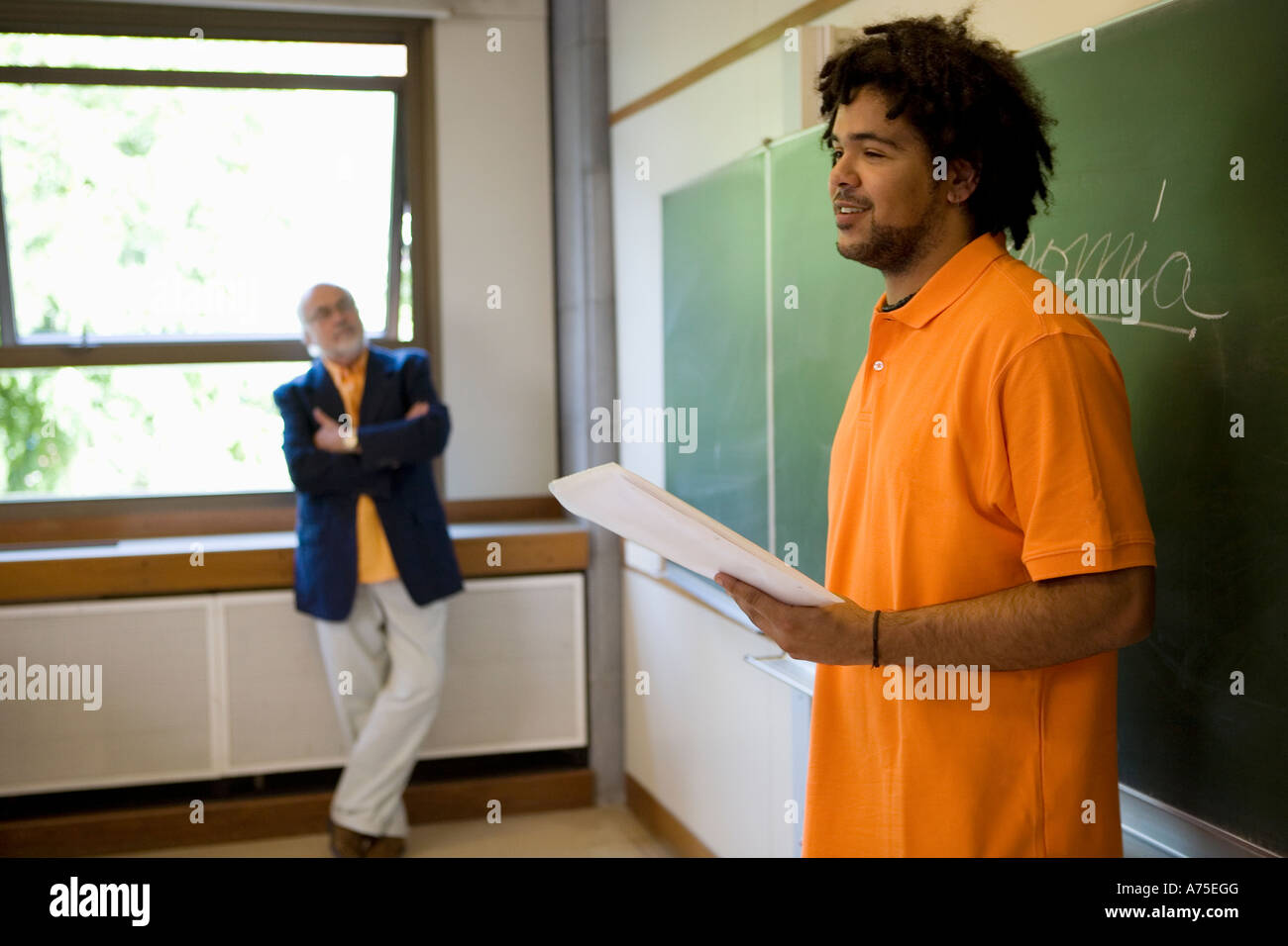 Male student speaking before class Stock Photo - Alamy