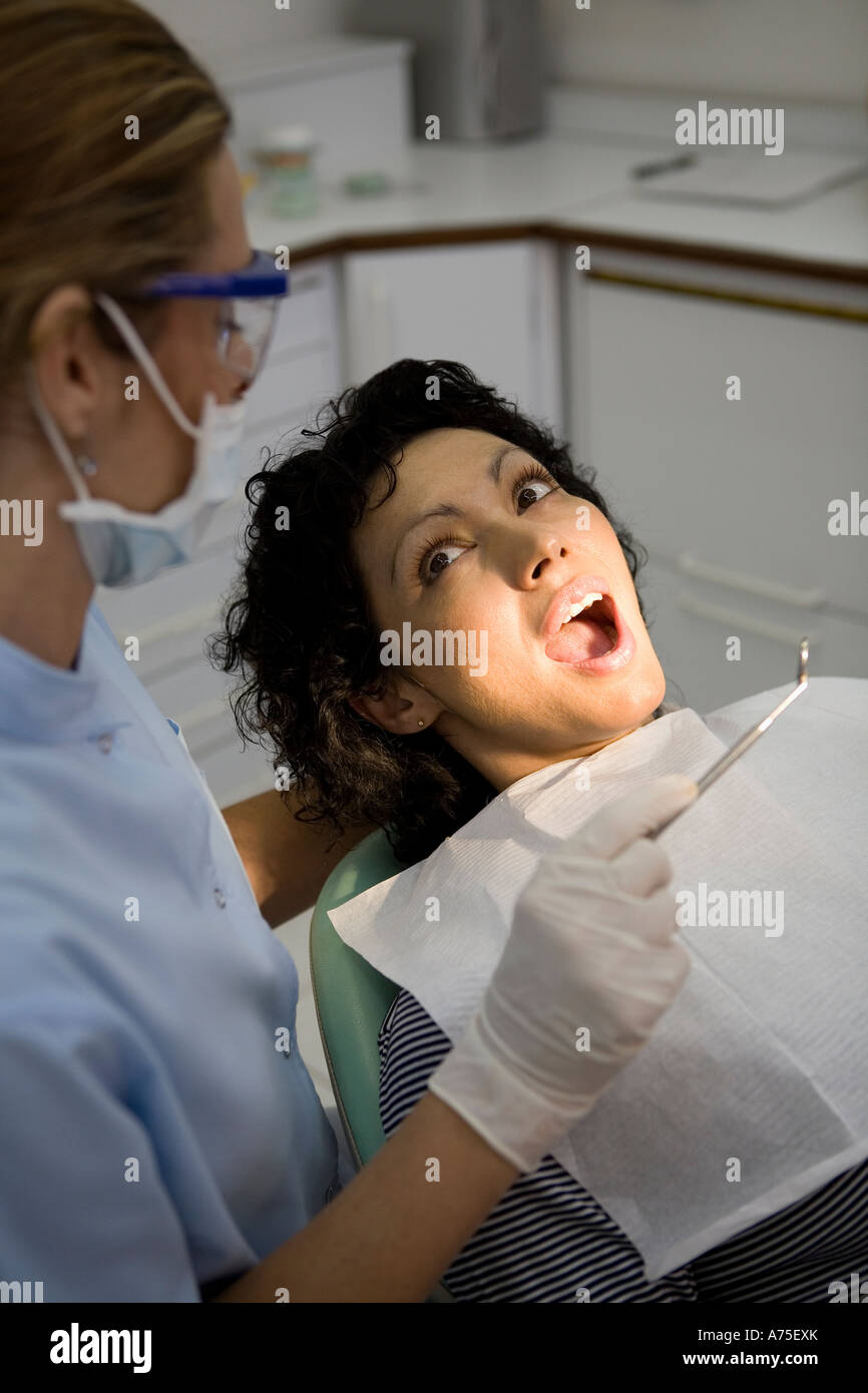 Dentist examining woman's teeth Stock Photo - Alamy