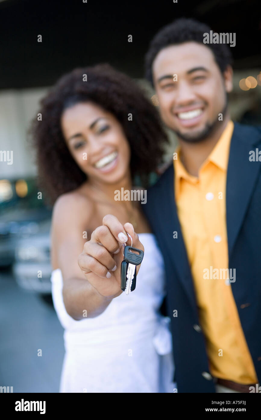 Couple showing off new car keys Stock Photo - Alamy