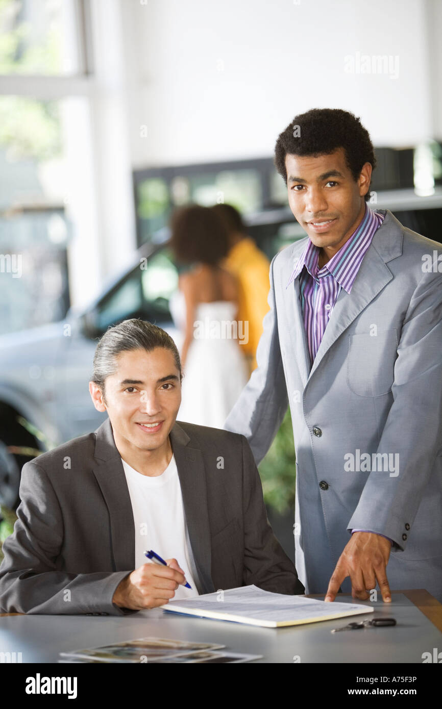 Man signing contract in car dealership Stock Photo - Alamy