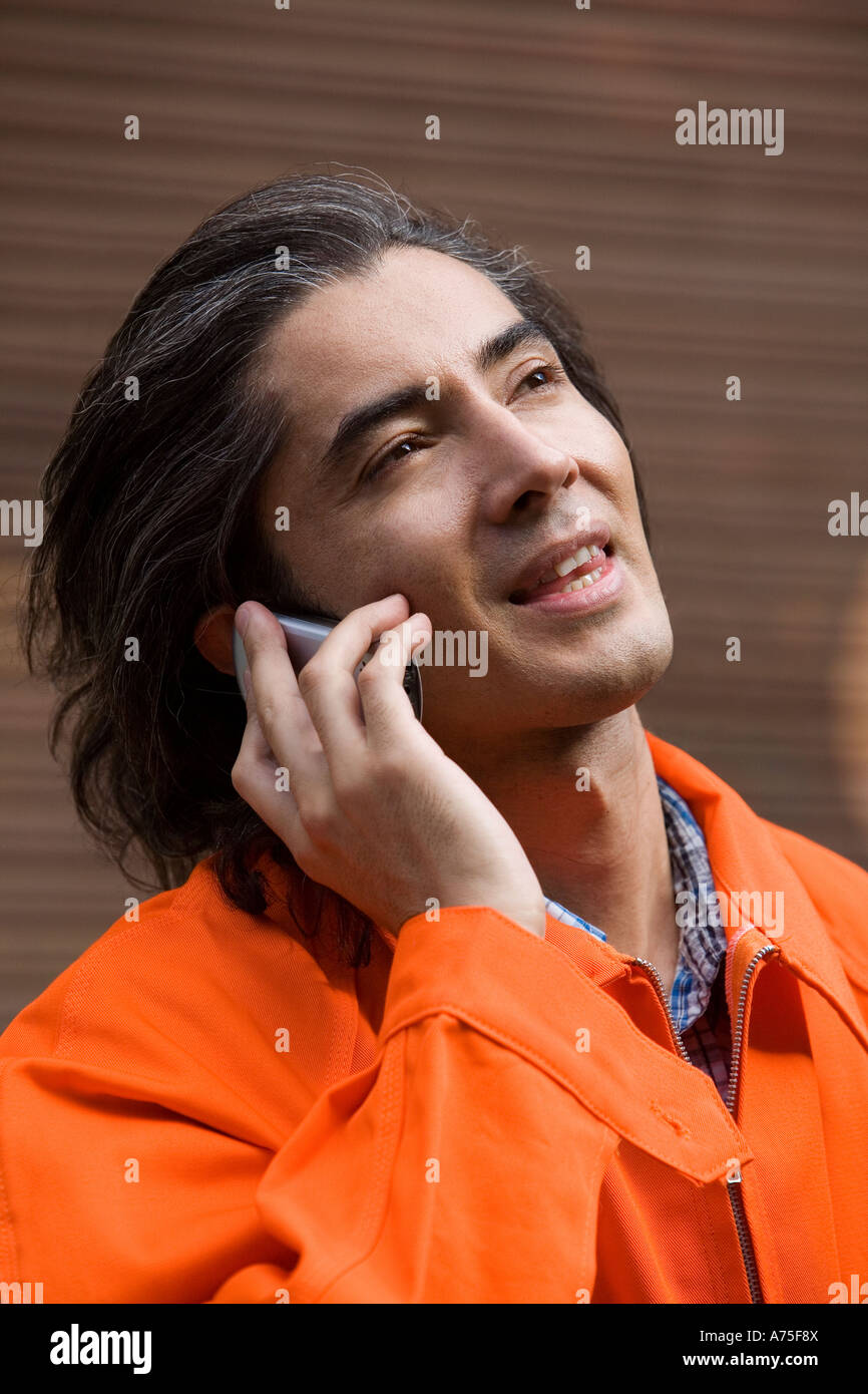 Blue-collar employee talking on his cell phone Stock Photo - Alamy