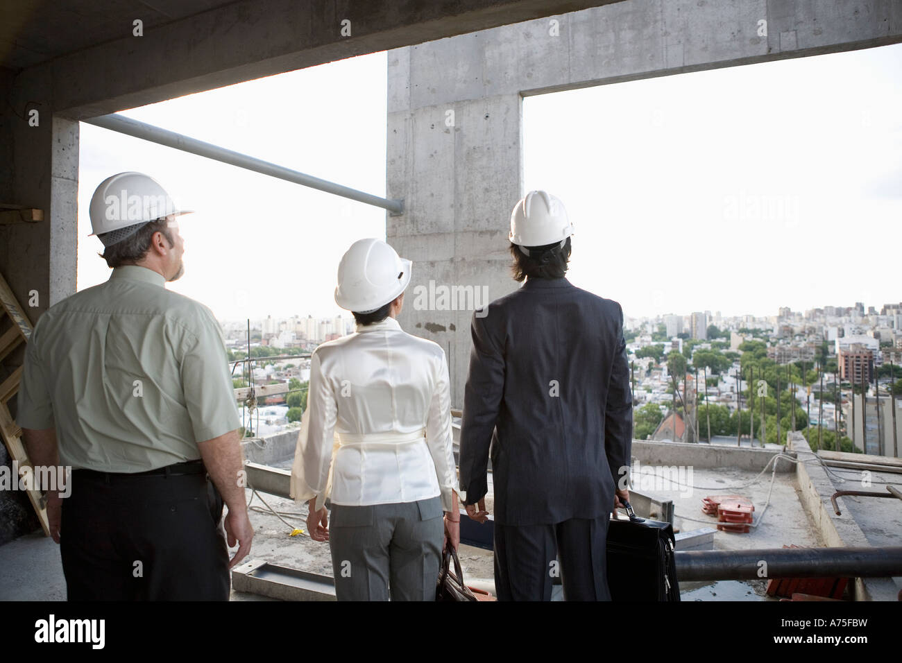 Businesspeople standing in construction area Stock Photo - Alamy