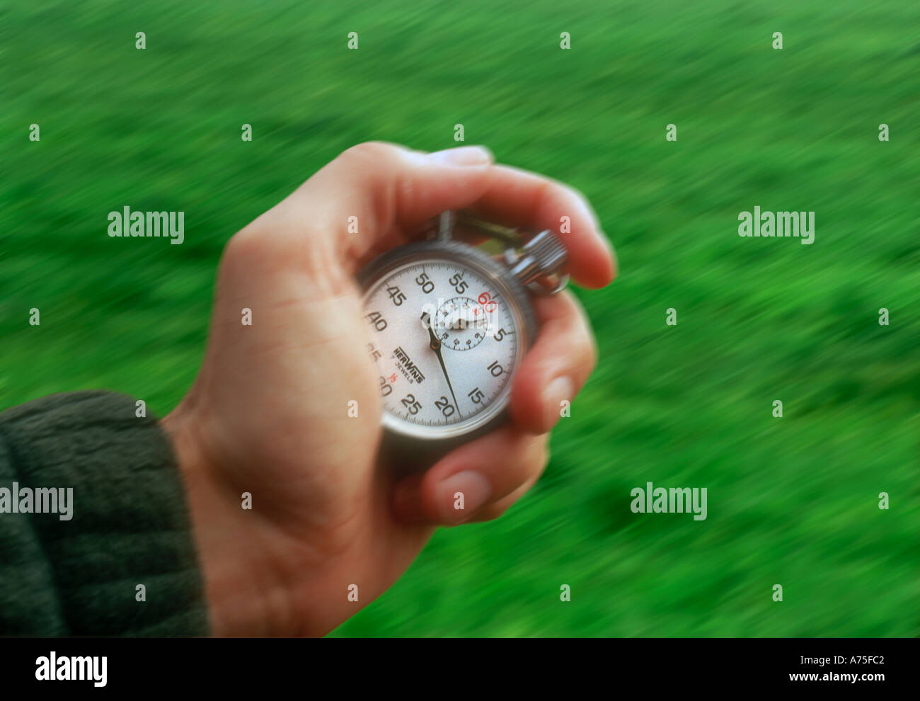 Hand holding a stopwatch Stock Photo - Alamy