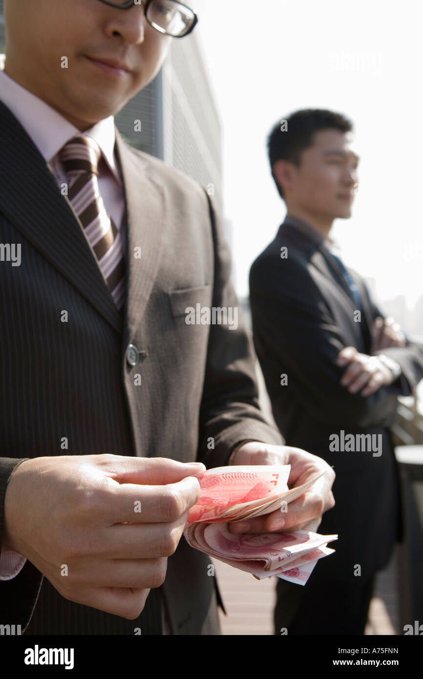 Businessman counting money Stock Photo - Alamy