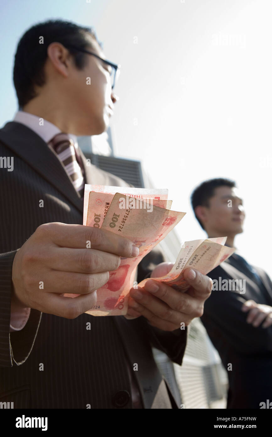 Businessman counting money Stock Photo - Alamy