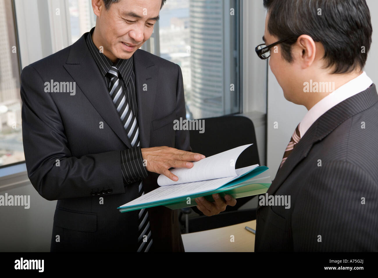 Two people reviewing documents in hi-res stock photography and images ...
