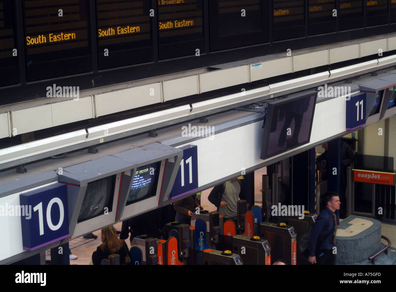 passengers pass through ticket barrier at victoria station london Stock ...