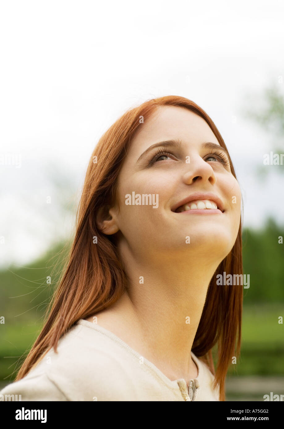Young woman looking up, portrait Stock Photo - Alamy