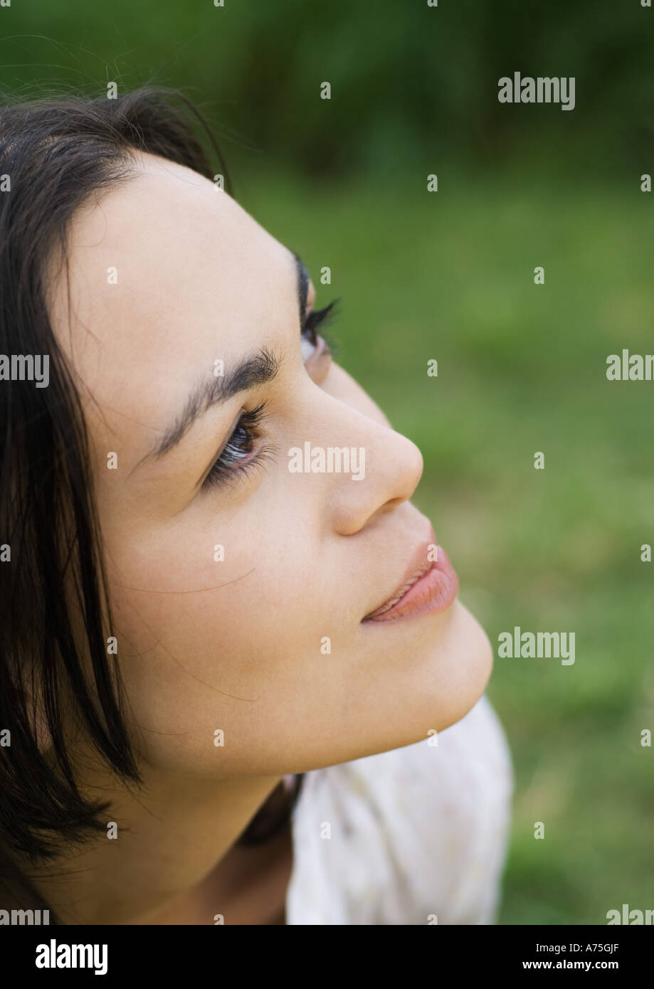 Young woman looking up, portrait Stock Photo - Alamy