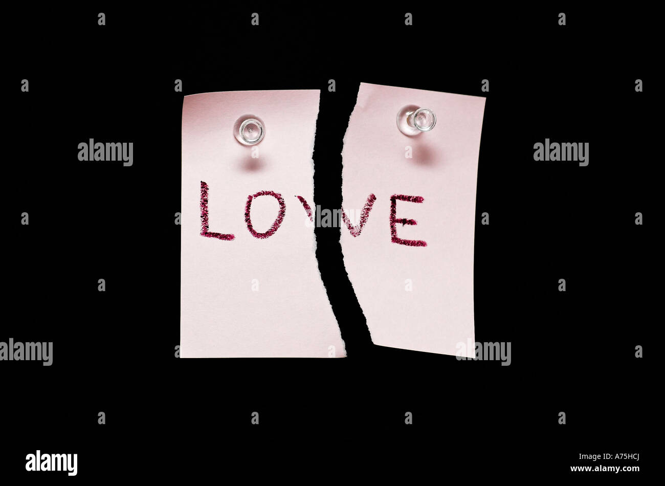 Torn adhesive note with word love written on it Stock Photo - Alamy