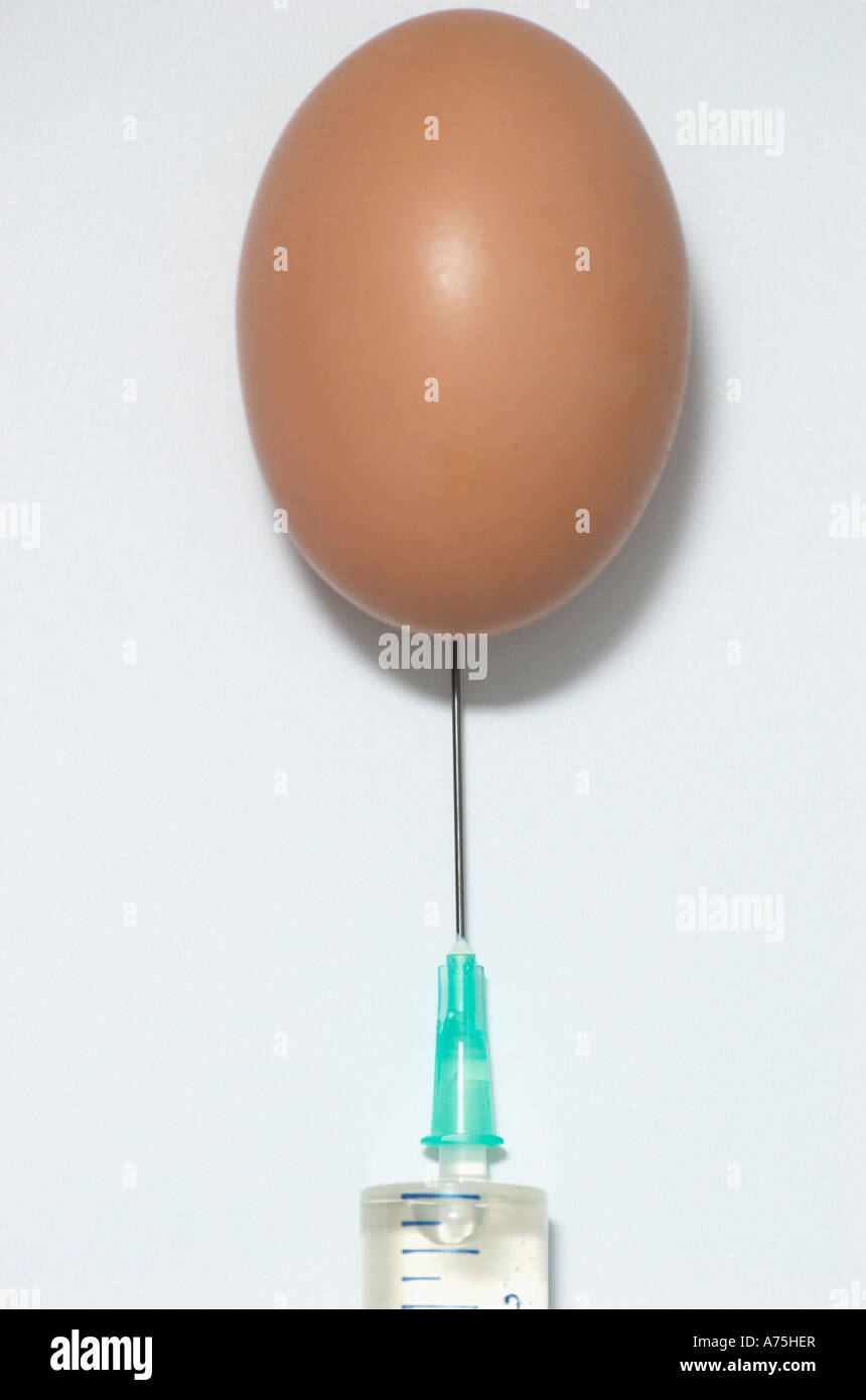 Syringe and egg Stock Photo - Alamy