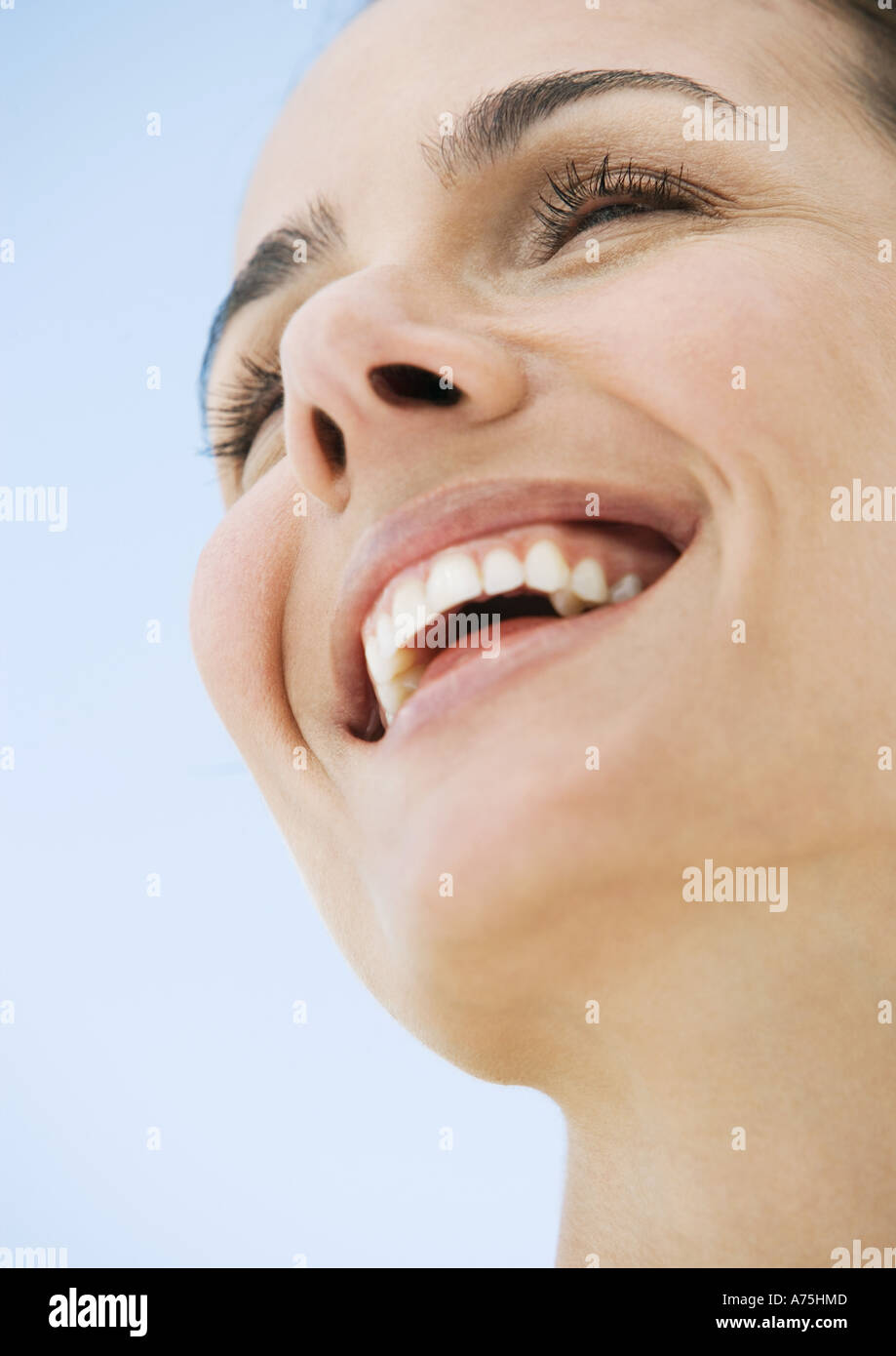 Woman smiling, low angle view Stock Photo - Alamy