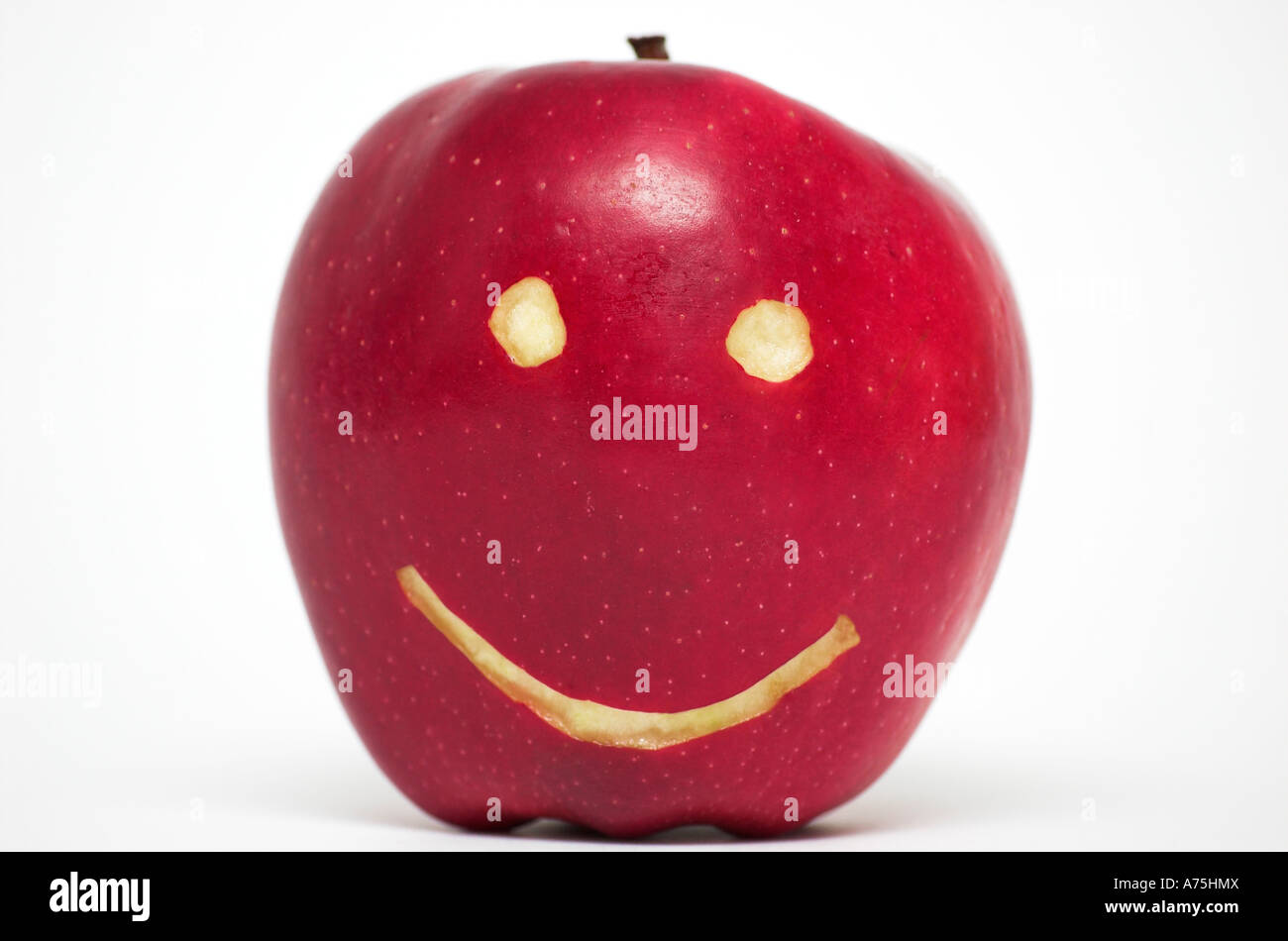 Smiley face on red aple Stock Photo - Alamy