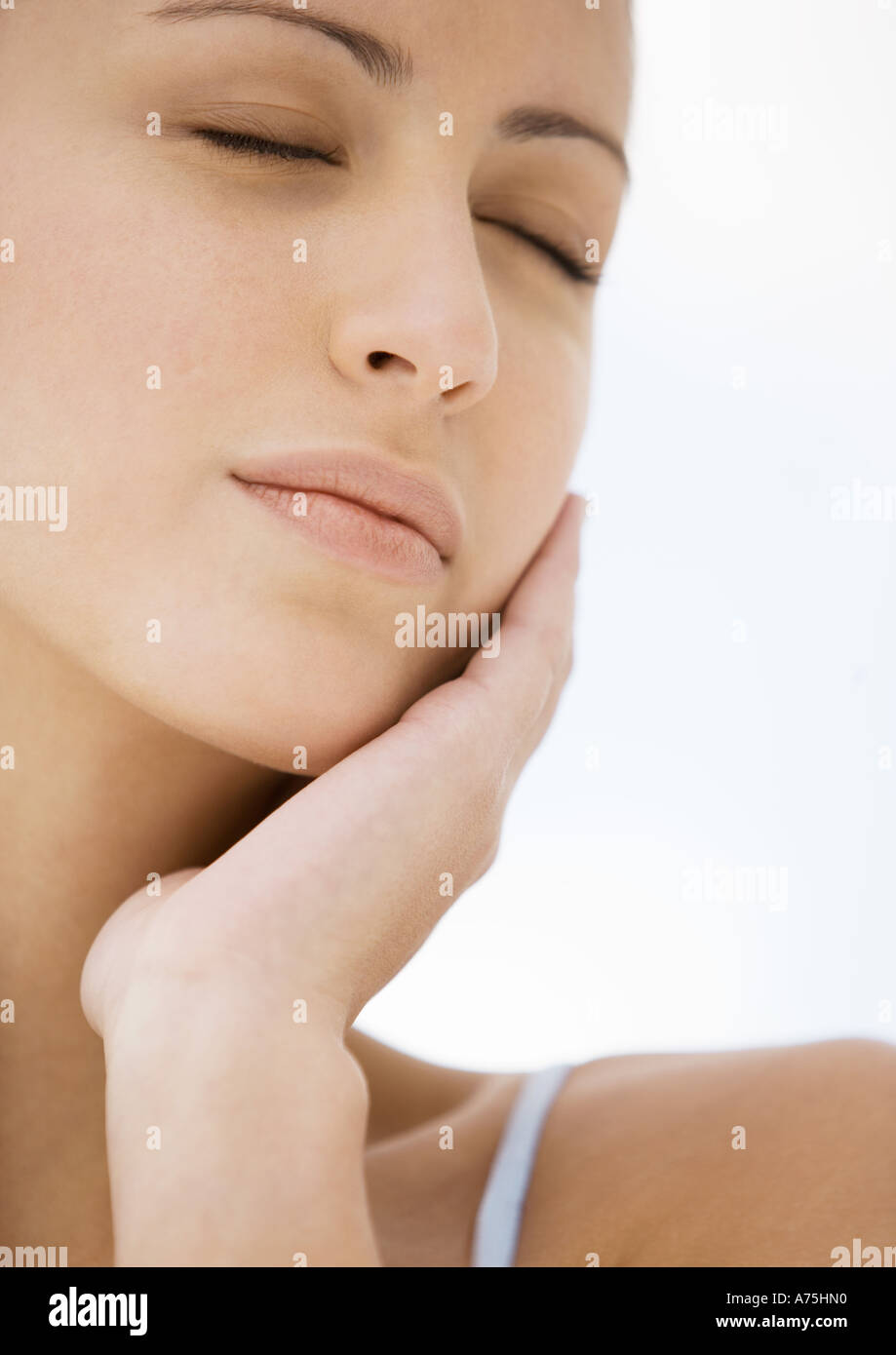 Woman resting face on hand with eyes closed Stock Photo - Alamy