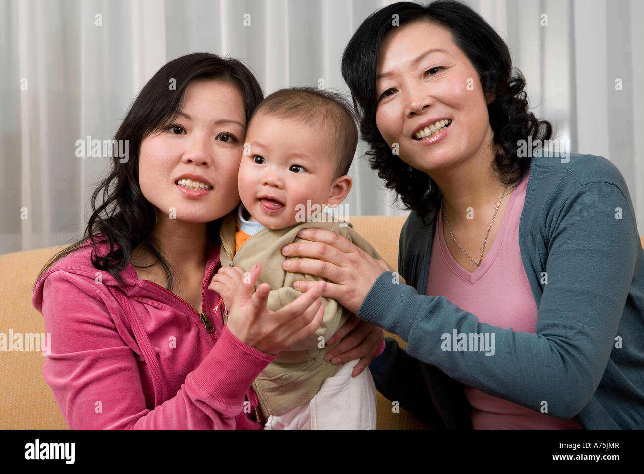 Three generations of family smiling Stock Photo - Alamy