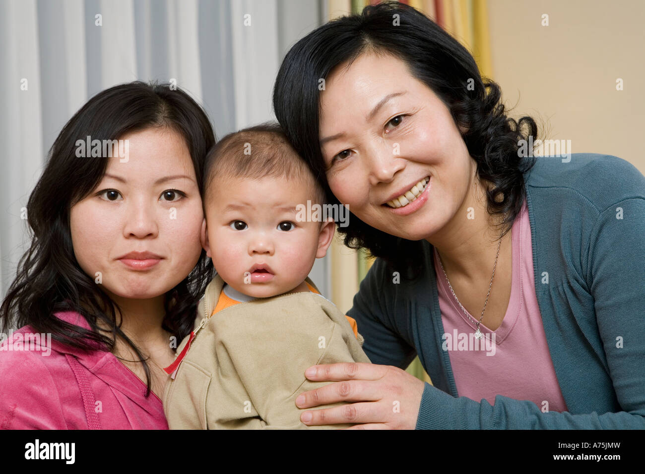 Three generations of family smiling Stock Photo - Alamy