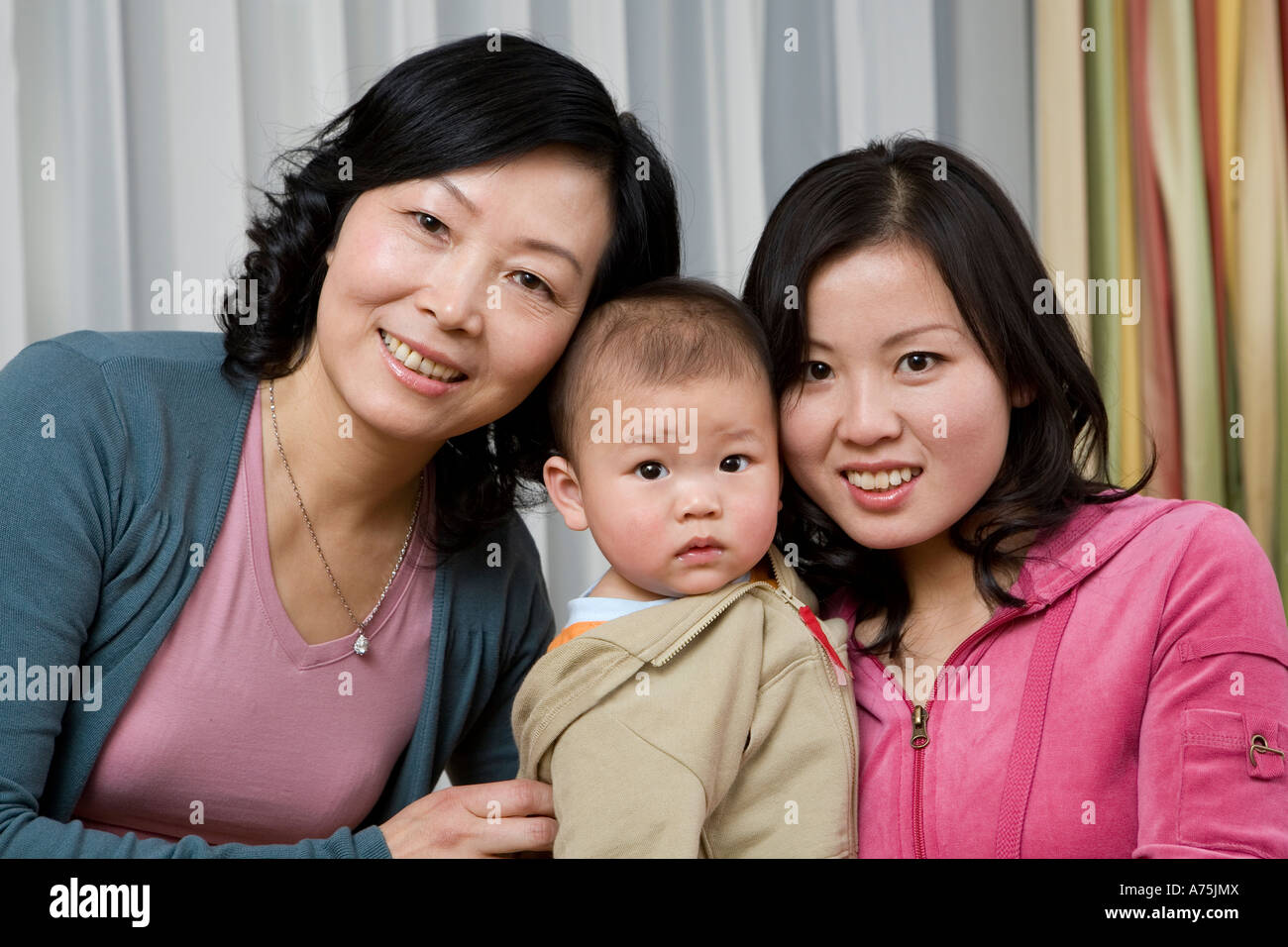 Three generations of family smiling Stock Photo - Alamy
