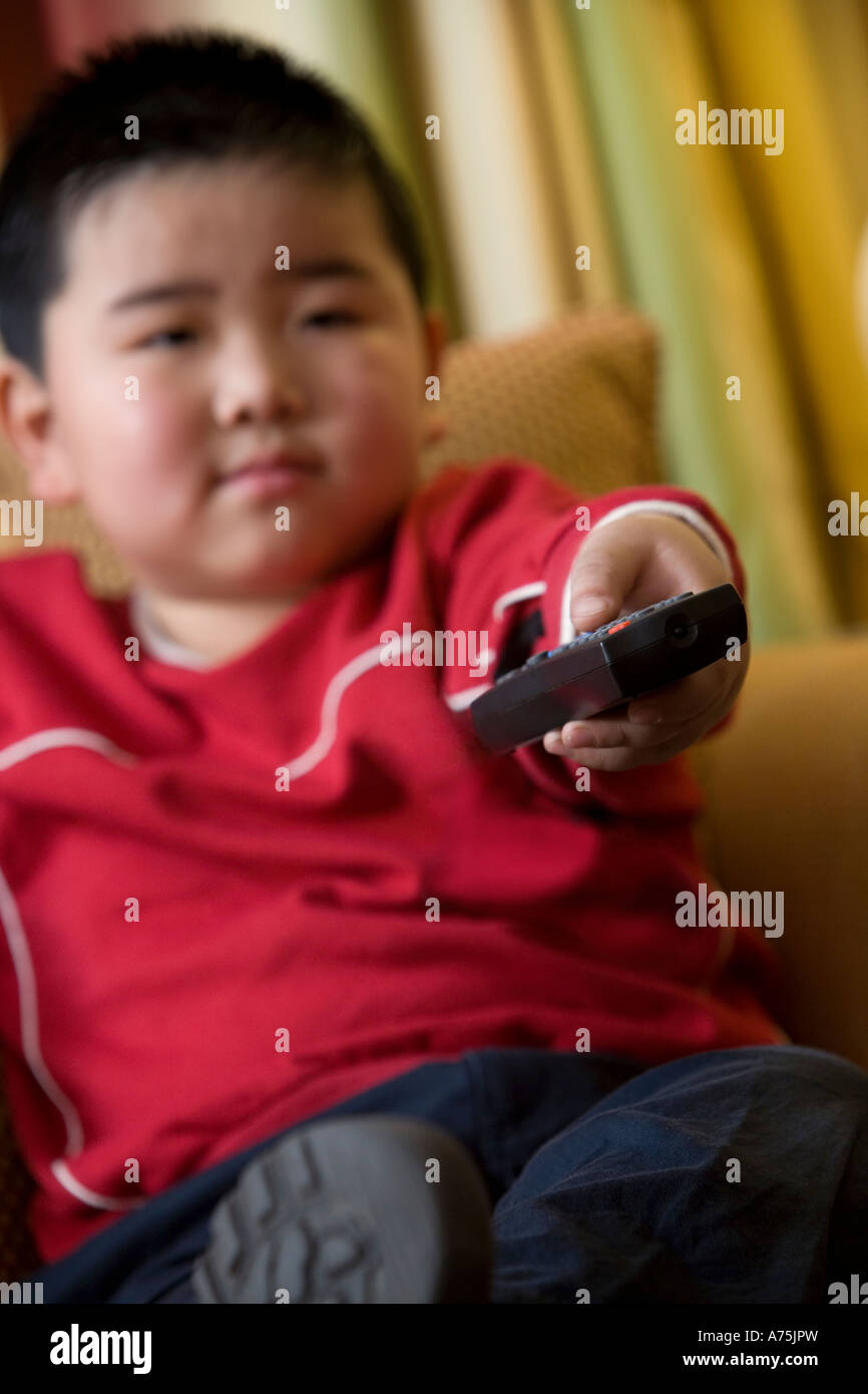 Young boy using remote control Stock Photo - Alamy