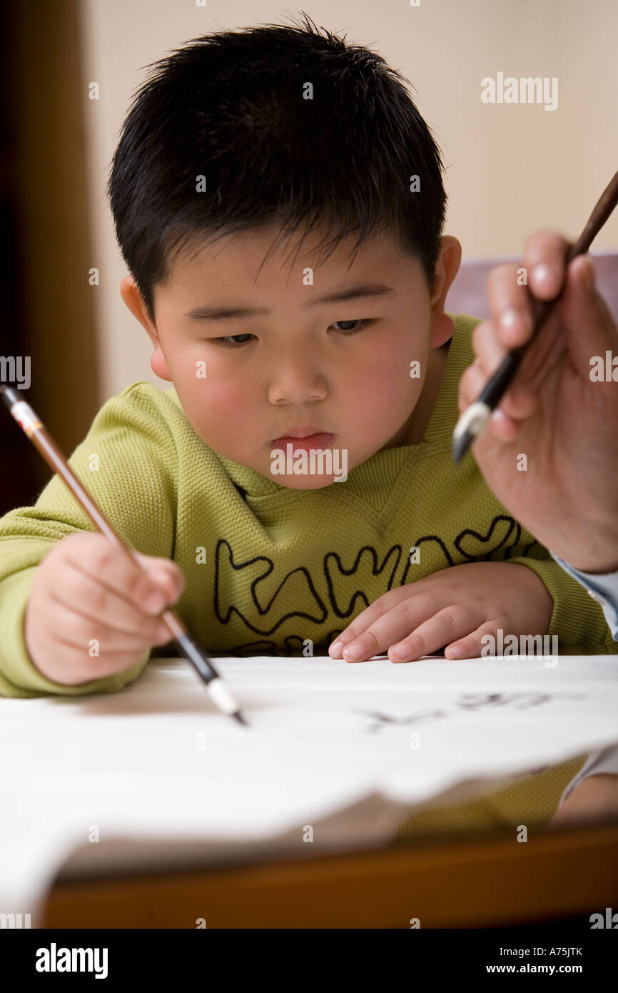 Young boy learning calligraphy Stock Photo - Alamy