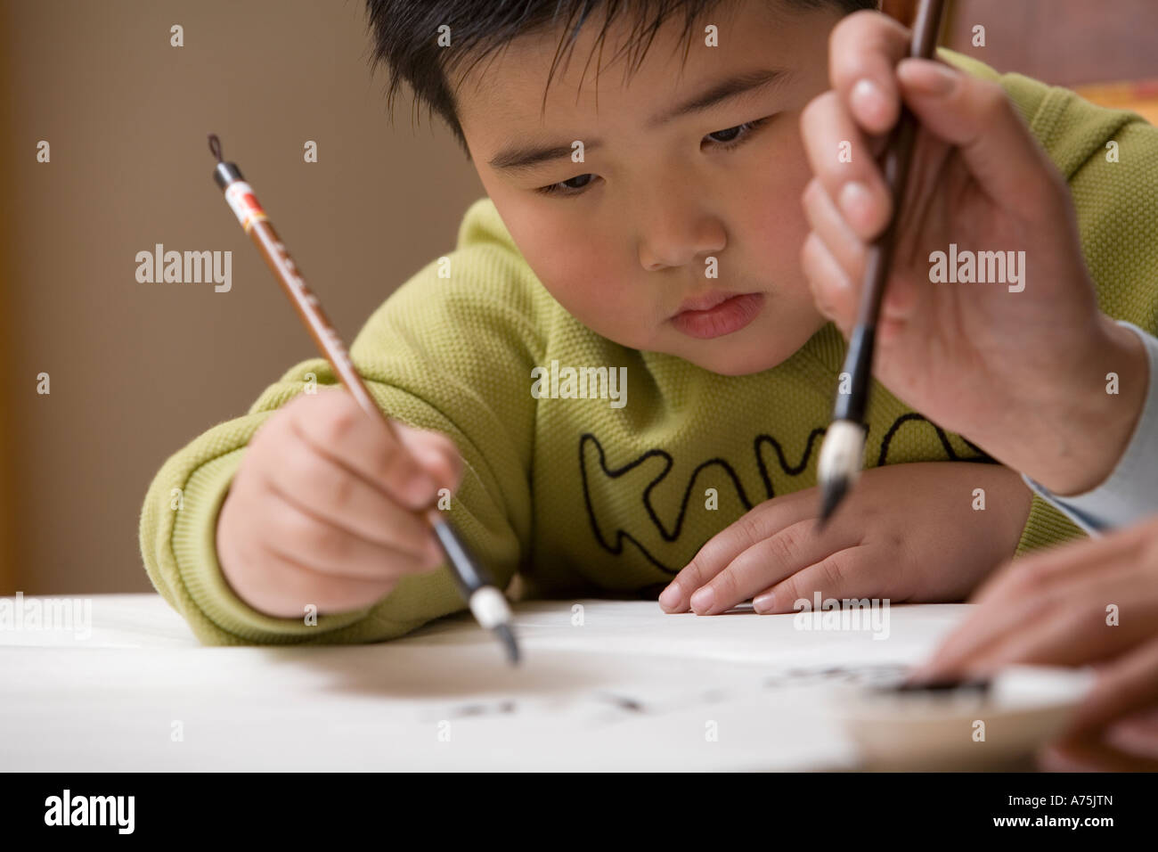 Boy learning calligraphy chinese hi-res stock photography and images ...